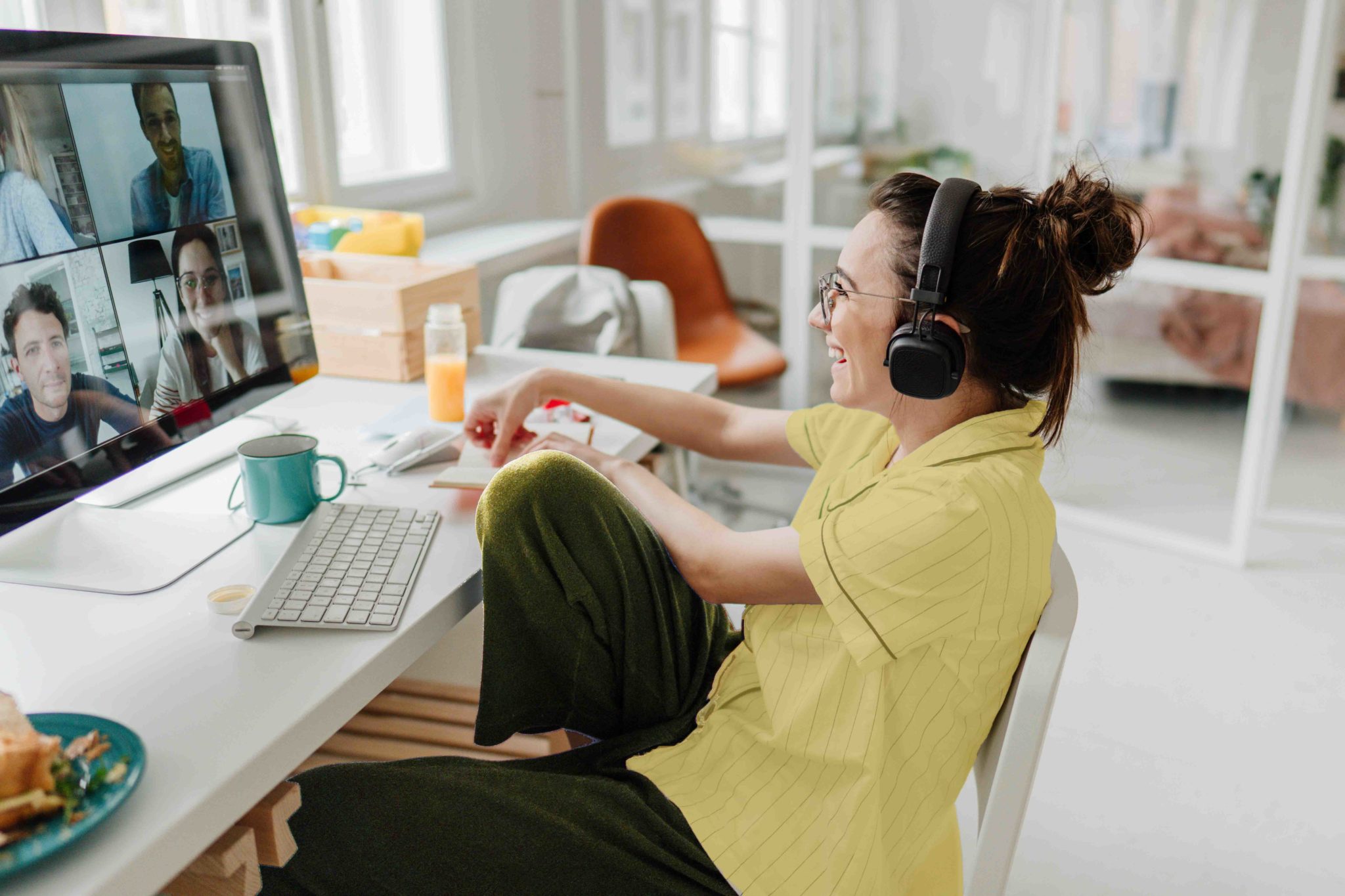 Smiling woman having a video call with her friends - Iventa